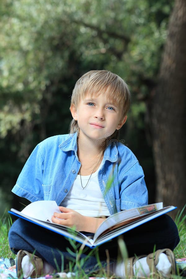 Boy with book stock image. Image of grass, person, forest - 16802387