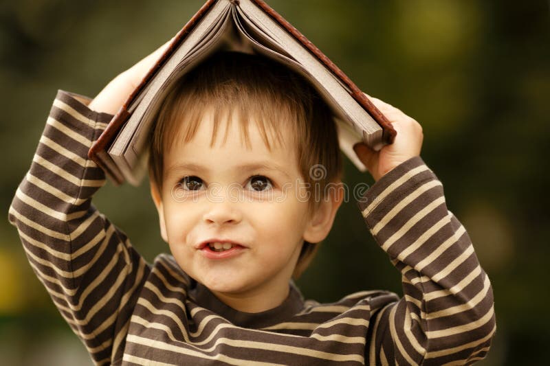 Boy with book stock photo. Image of floor, prank, adorable - 28246648