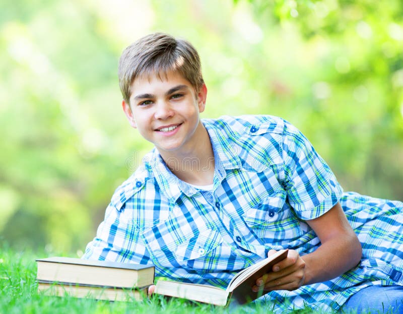 Boy with books stock photo. Image of lawn, male, reading - 33685010
