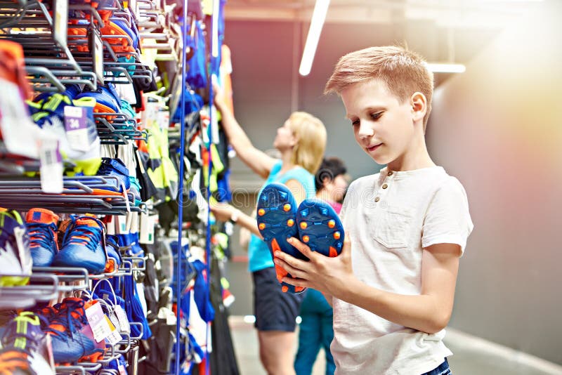 Boy with Boots in a Football Store Stock Photo - Image of healthy ...