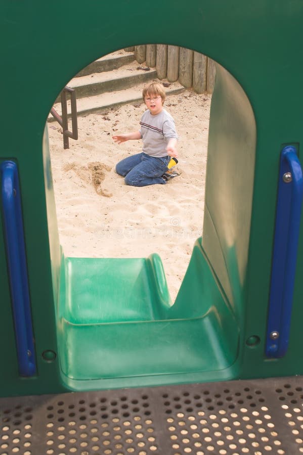 Boy at the bottom of slide stock image. Image of playground - 3444077