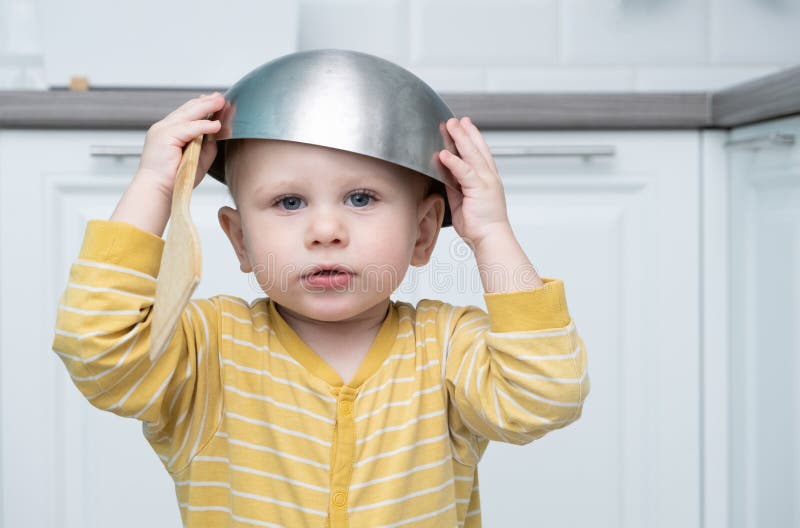 Boy with a Bowl on His Head. Games in the Kitchen. Stock Photo - Image ...