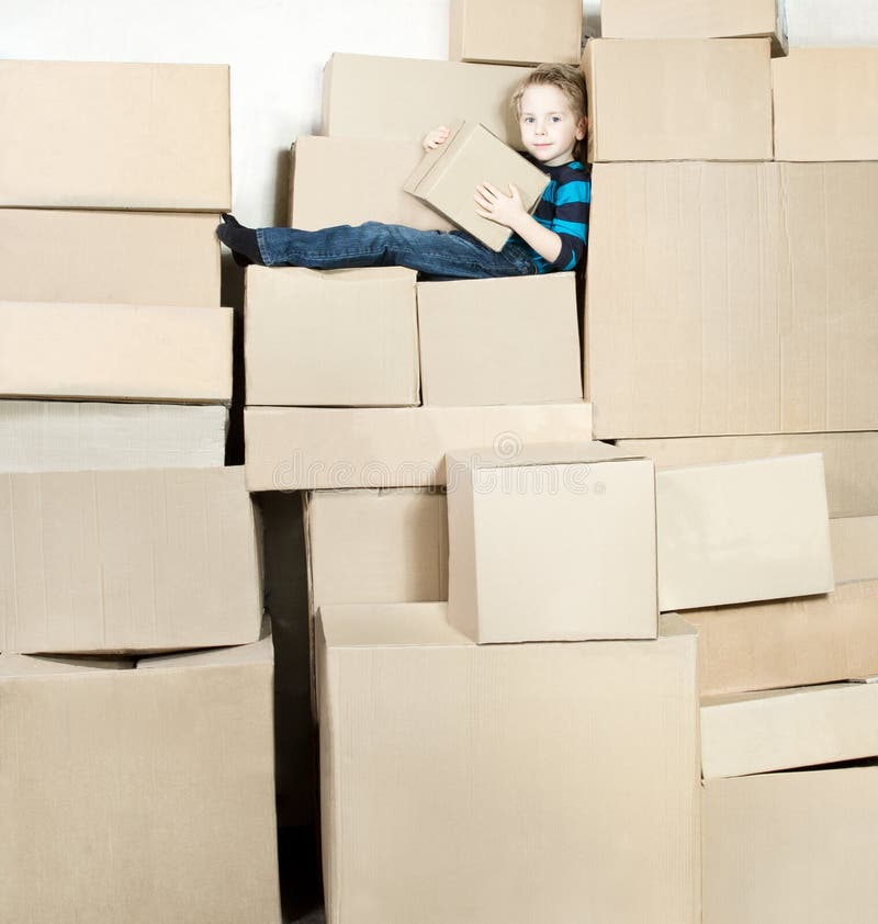 Boy Sitting in Front of Carton Boxes Stock Image - Image of caucasian ...