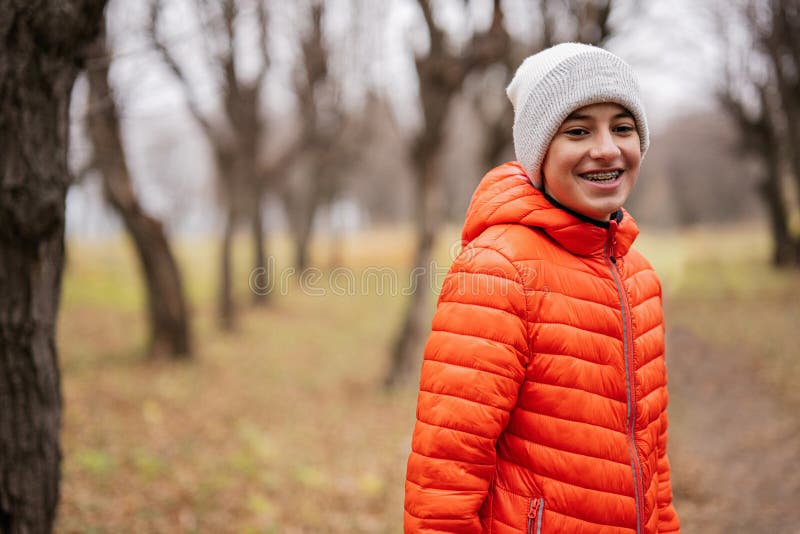 Boy with Braces , Wear Orange Jacket and Whit Hat in Autumn Forest ...