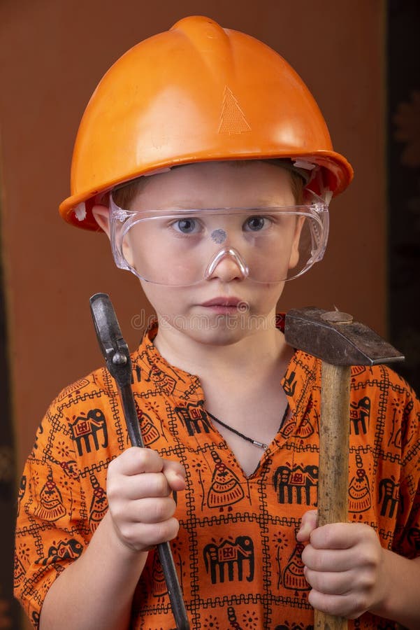 Boy in builder`s clothes stock image. Image of contractor - 150095913