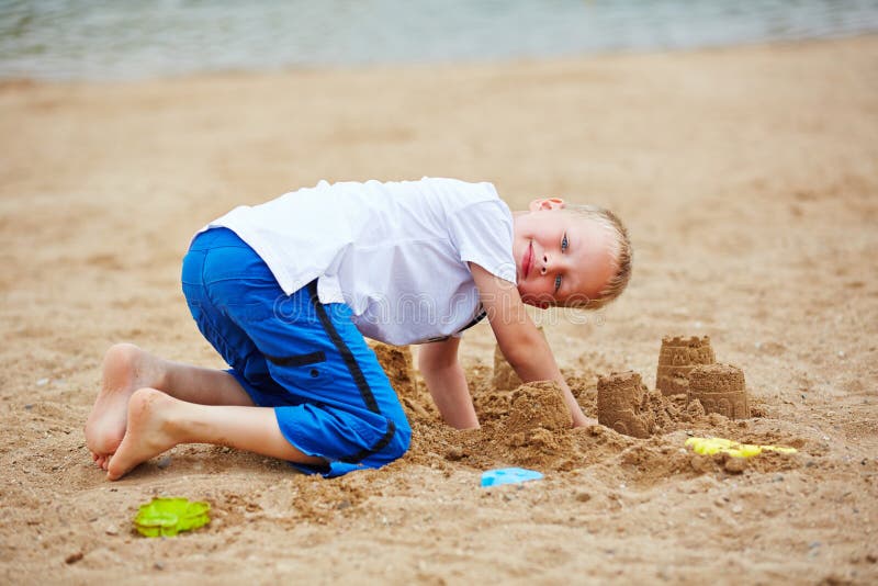 Boy Building Sand Castle in Summer Stock Photo - Image of holidays ...