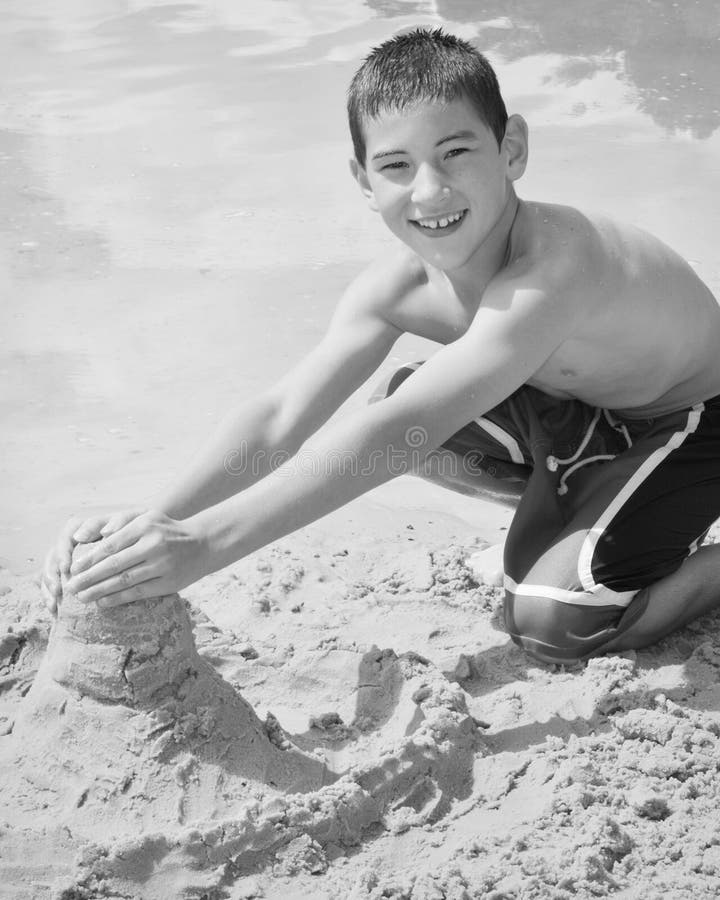 Boy Building Sand Castle stock photo. Image of happy - 76762398
