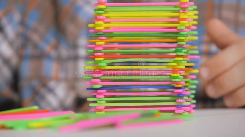 Boy Builds a Pyramid of Colored Sticks. Table Games. Stock Footage ...