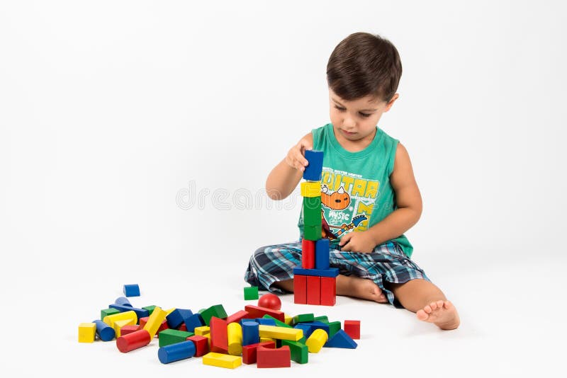 Boy builds a tower stock photo. Image of multicolored - 33298806