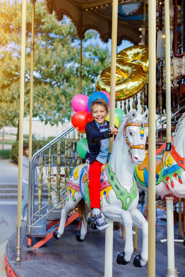 Boy with Bunch of Colorful Balloons on the Carousel in Paris. Stock ...