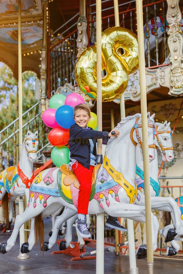 Boy with Bunch of Colorful Balloons on the Carousel in Paris. Stock ...