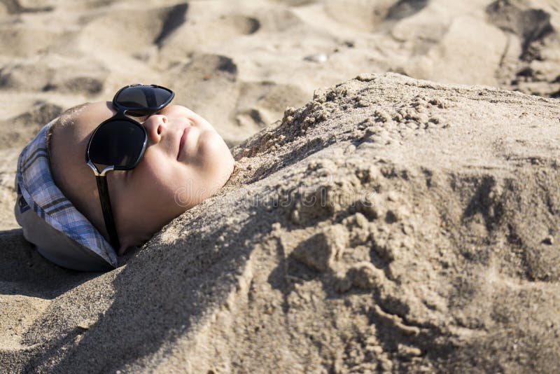 Boy Buried In The Sand Beach Stock Image - Image of active, happy ...