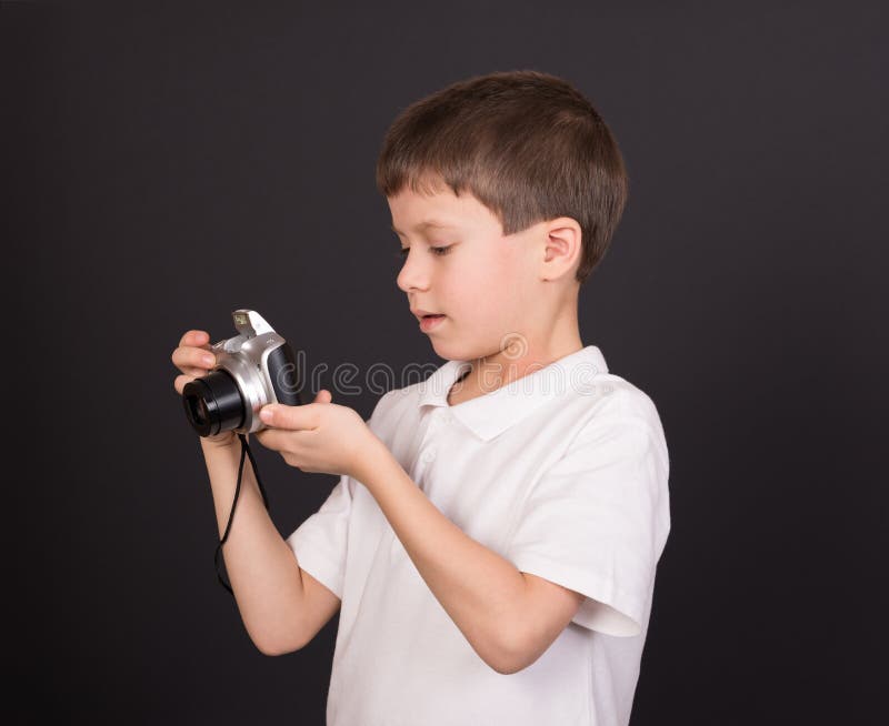 Boy with camera on black stock photo. Image of front - 47601962