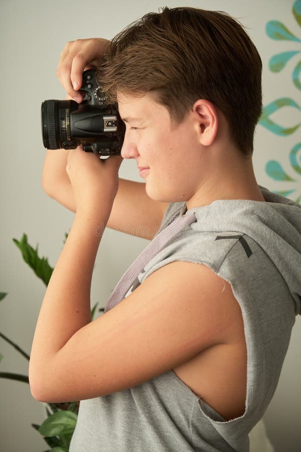 A Boy with a Camera Next To a Laptop Computer Stock Photo - Image of laptop, camera: 298072998