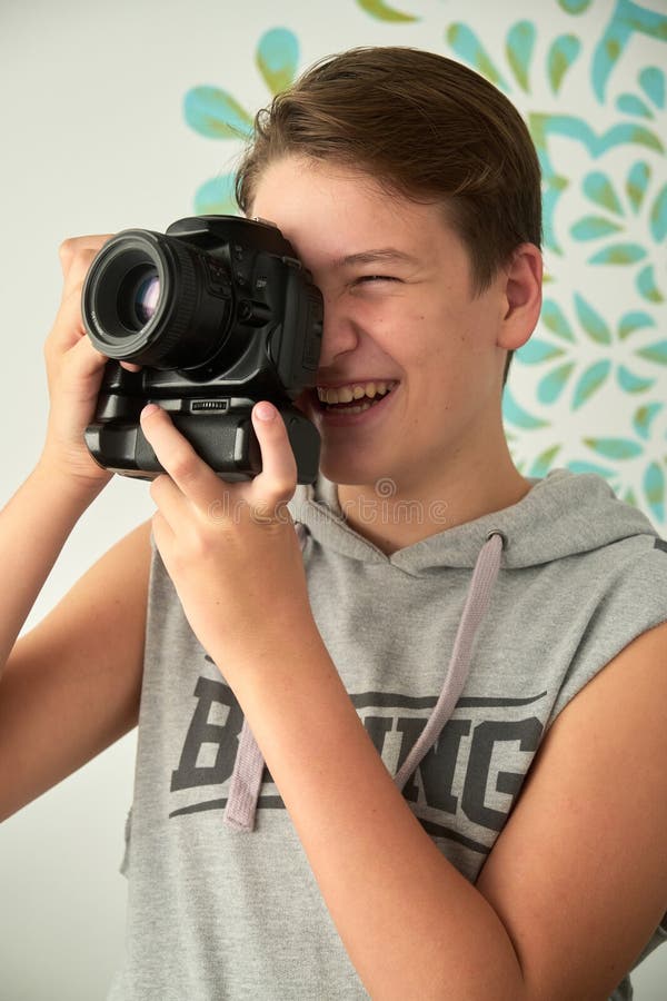 A Boy with a Camera Next To a Laptop Computer Stock Photo - Image of ...
