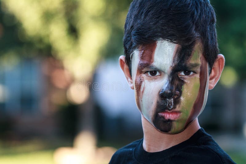 Boy in camouflage stock image. Image of tough, frown - 34860407