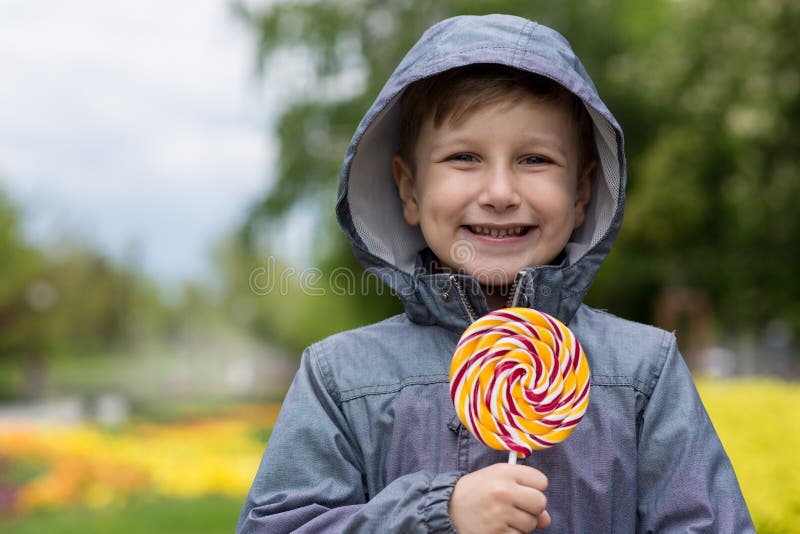 Boy with candy stock image. Image of congratulation, approval - 53906545