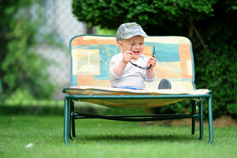 Boy in cap stock photo. Image of sitting, green, face - 26054164