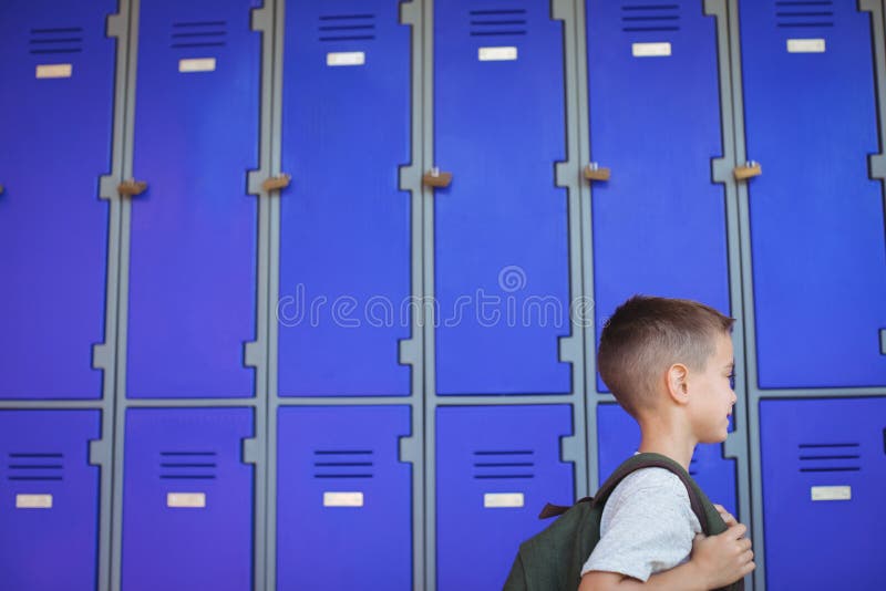 Boy Carrying Backpack Against Lockers Stock Image - Image of casual ...