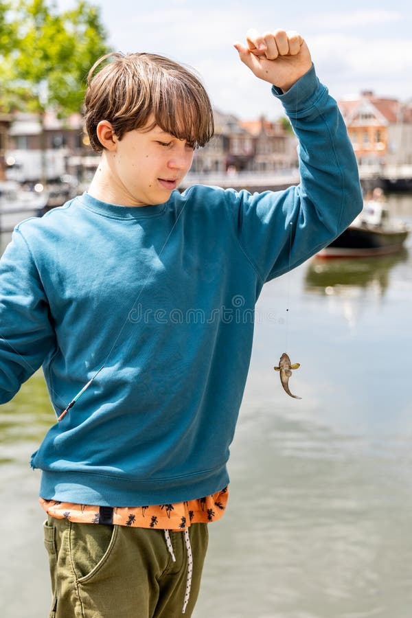 The Boy Caught a Goby Fish on a Canal in Amsterdam Stock Photo - Image ...