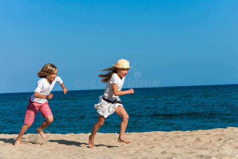 Kids chasing each other. stock image. Image of beach - 31229373