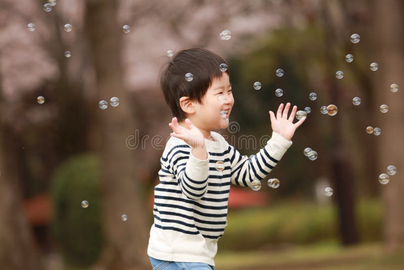 A Boy Chasing a Shabon Ball Stock Image - Image of clothing, children ...