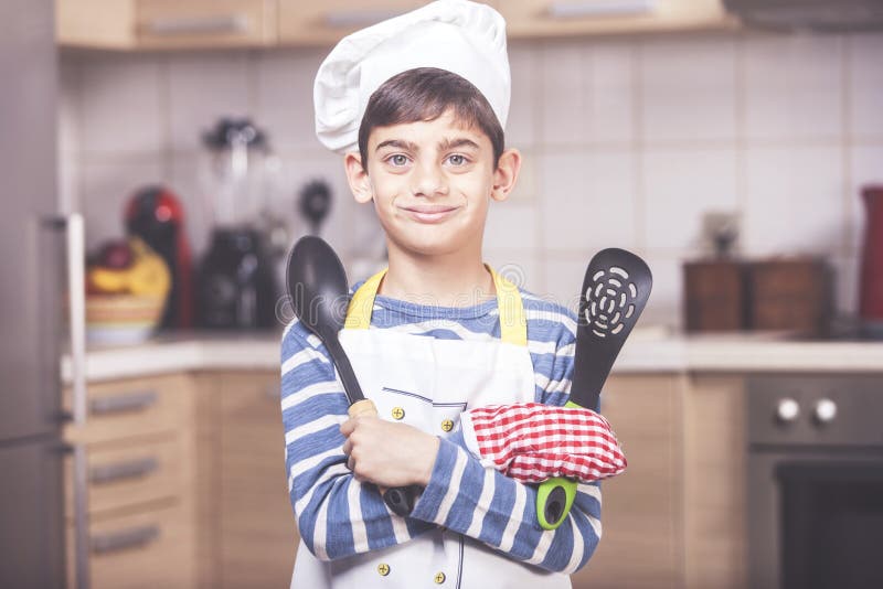 Boy chef in the kitchen stock photo. Image of children - 98774030