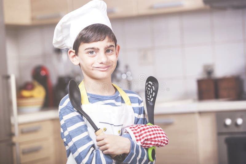 Boy chef in the kitchen stock image. Image of child - 116169899