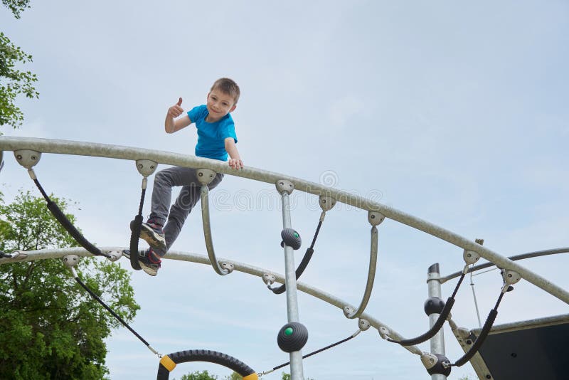 A Boy Child Having Fun Daring Climbs the Playground Stock Photo - Image ...