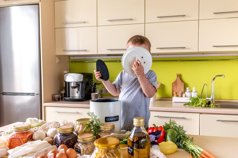Boy Child Playing in the Kitchen with a Lid from the Compost Bin. Zero ...
