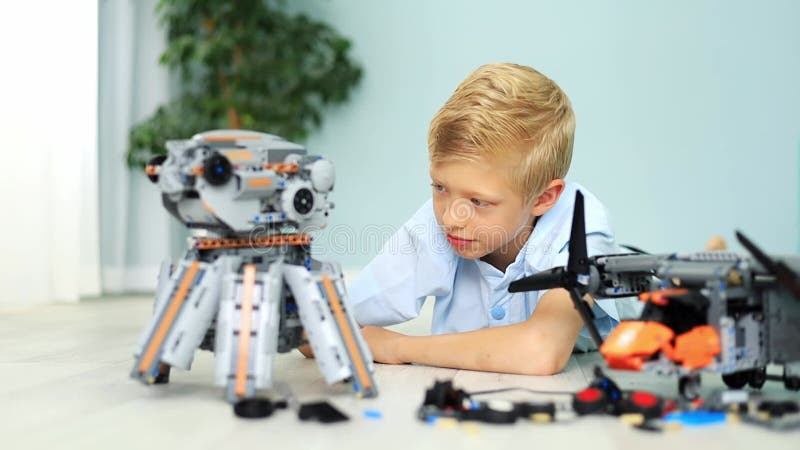 A Boy Child Plays with a Robot from a Radio-controlled Constructor ...