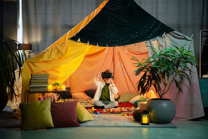 The Boy Chilling Together Inside a Blanket Fort while Playing with a ...
