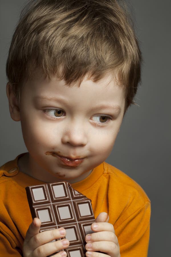 Boy with chocolate stock photo. Image of indulgence, shot - 23002268