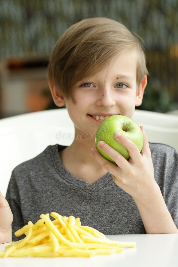 Boy Chooses Fruit or Fast Food Stock Image - Image of lunch, white ...