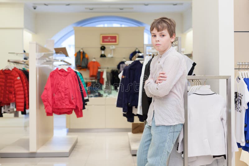 The Boy Chooses Modern Clothes in Clothing Store Stock Image - Image of ...