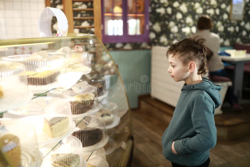Boy choosing cake stock image. Image of assortment, people - 147759439