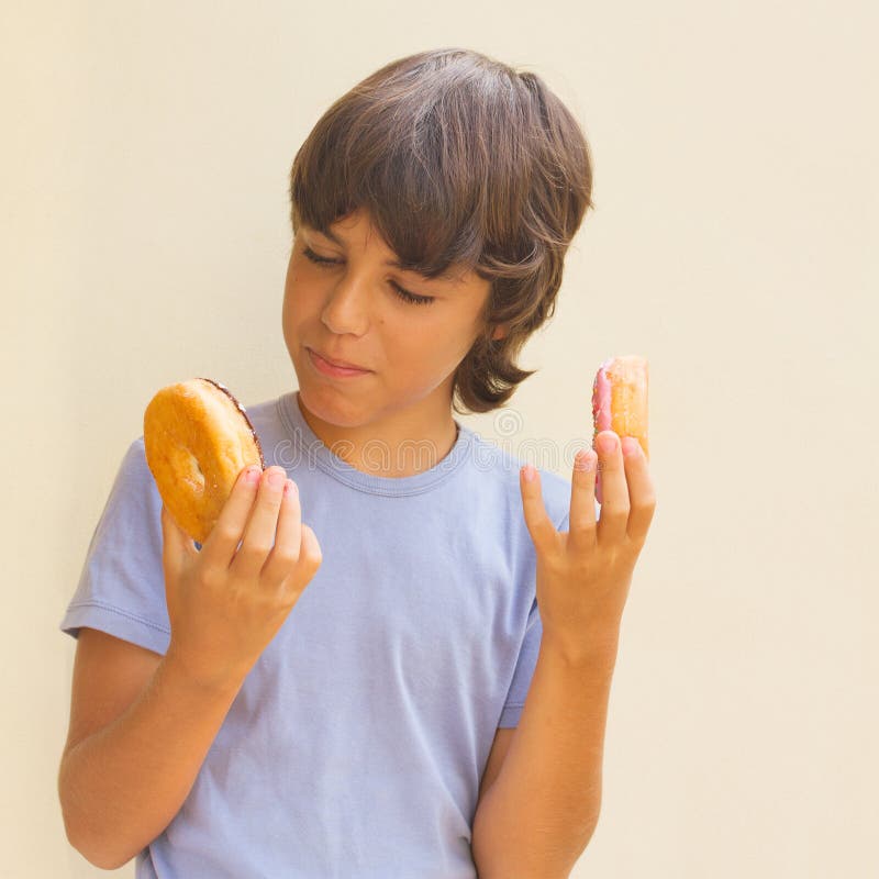 Boy choosing one of donuts stock image. Image of donut - 32682027