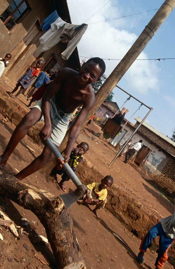 A Boy Chopping Wood, Uganda Editorial Stock Image - Image of people ...