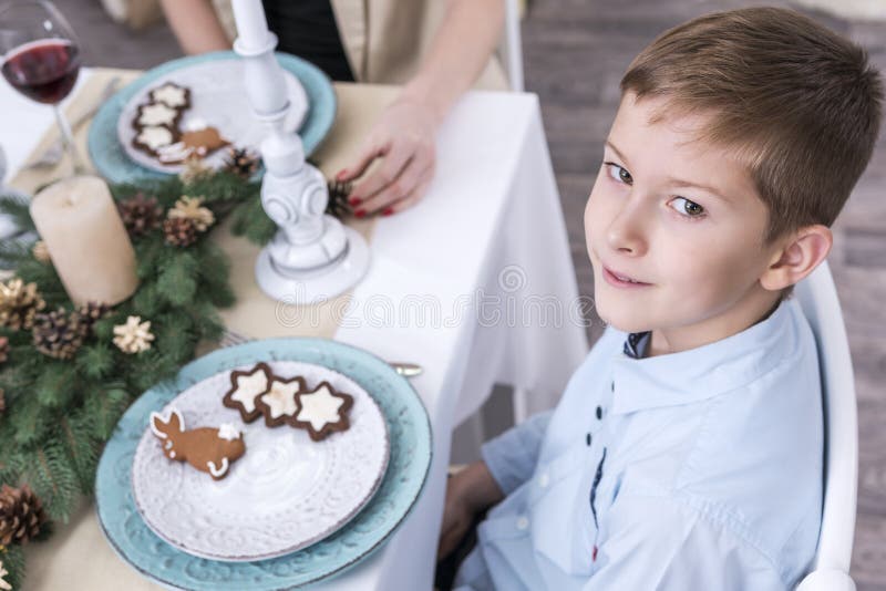 Boy at the christmas table stock photo. Image of beautiful - 127151976