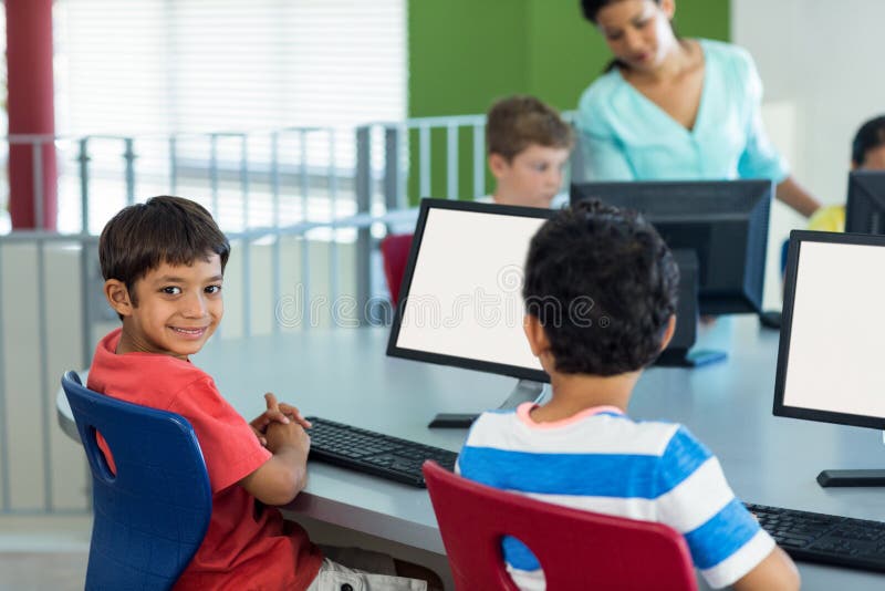Boy with Classmates and Teacher during Computer Class Stock Photo ...