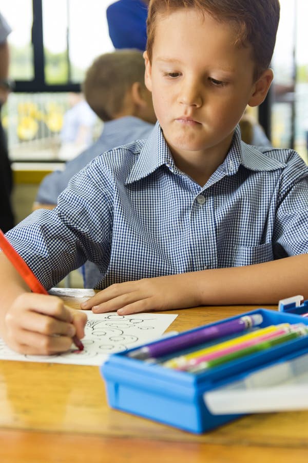 Boy in classroom working stock image. Image of classroom - 65250095