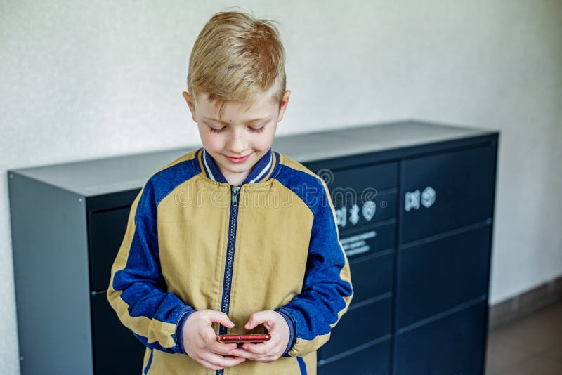 Boy Client Using Automated Self Service Post Terminal Machine or Locker ...
