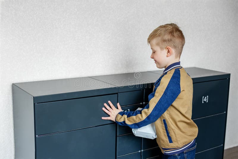 Boy Client Using Automated Self Service Post Terminal Machine or Locker ...