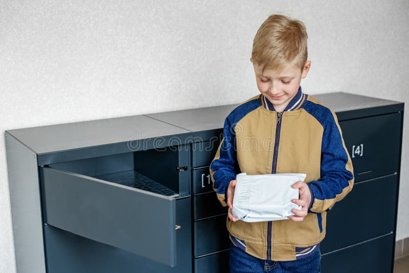 Boy Client Using Automated Self Service Post Terminal Machine or Locker ...