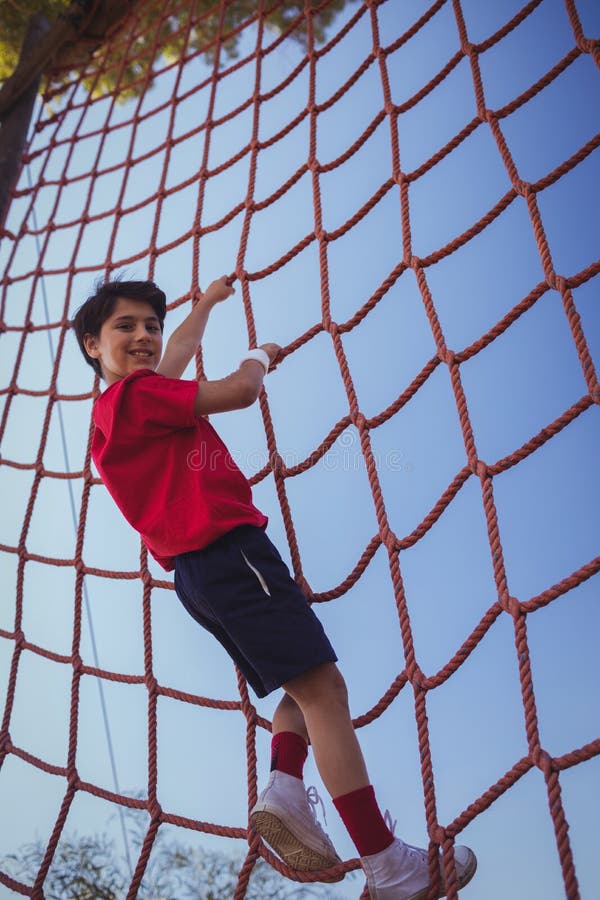 Boy Climbing a Net during Obstacle Course Training Stock Photo - Image ...