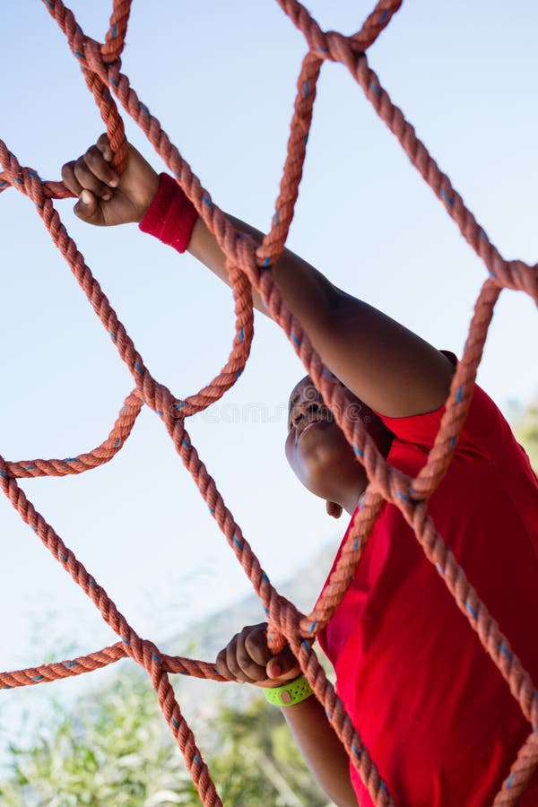 Boy Climbing a Net during Obstacle Course Training Stock Image - Image ...