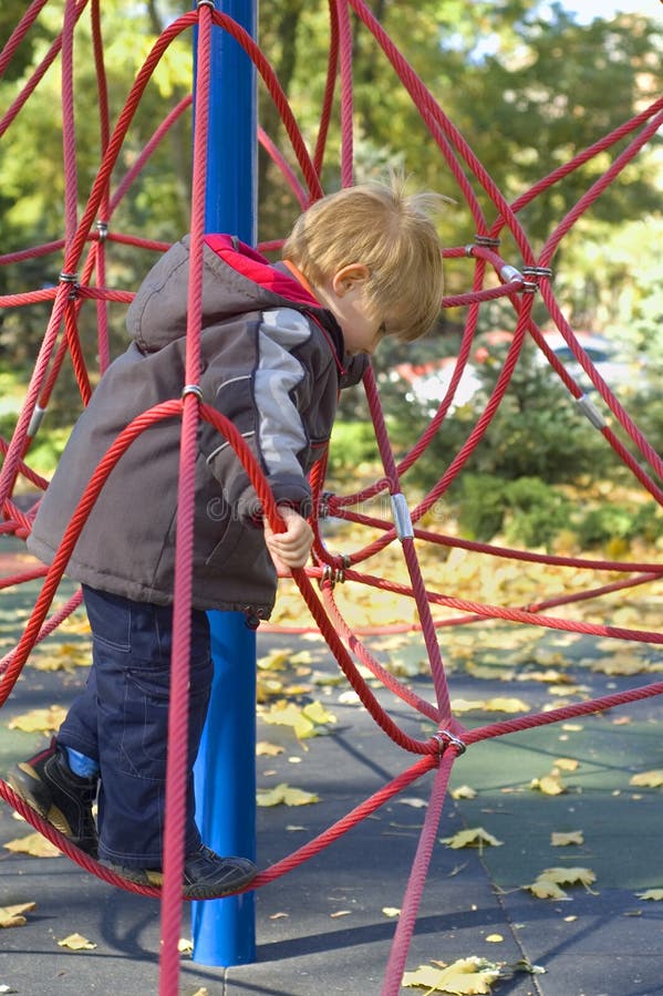 Boy climbing net of ropes stock image. Image of lifestyles - 12520117