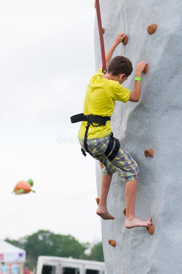 Boy climbing a rock wall stock photo. Image of recreation - 56068194