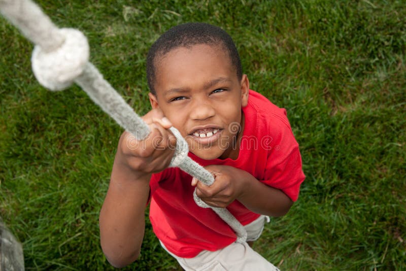 Boy climbing a rope stock image. Image of grasp, climb - 26005685