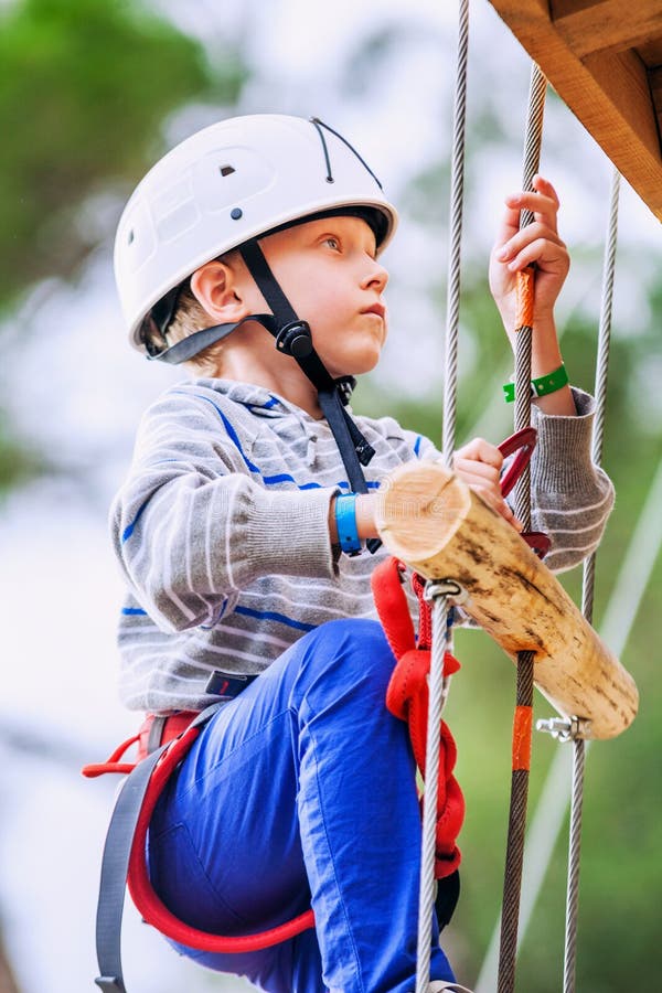 Boy Climbing Rope-ladder in Adrenalin Park Stock Photo - Image of fear ...